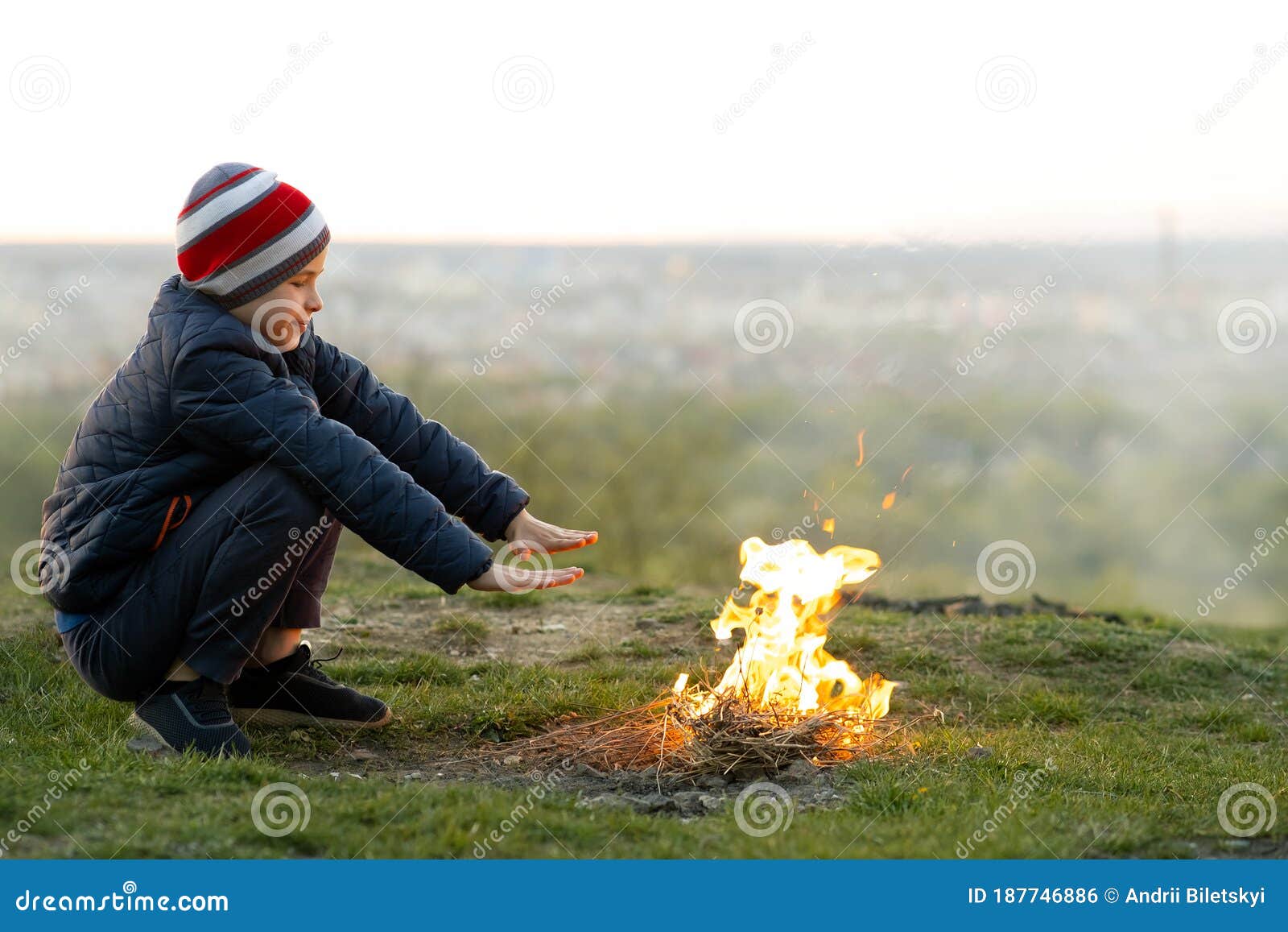 Child Boy Warming Near Bonfire Outdoors in Cold Weather Stock Photo ...