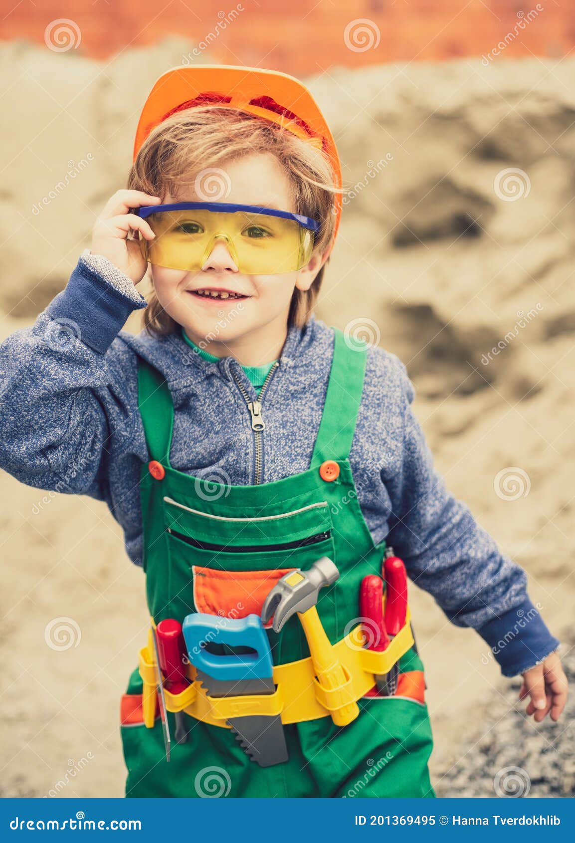 A Child Builder Holds A Construction Mixer Against The Background Of A ...