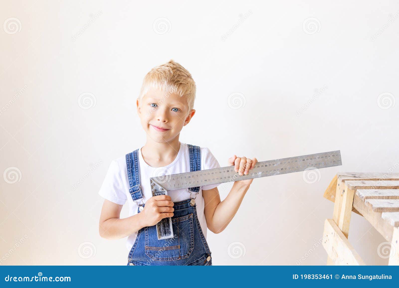 Child Builder Measures a White Wall with a Construction Ruler, Space ...