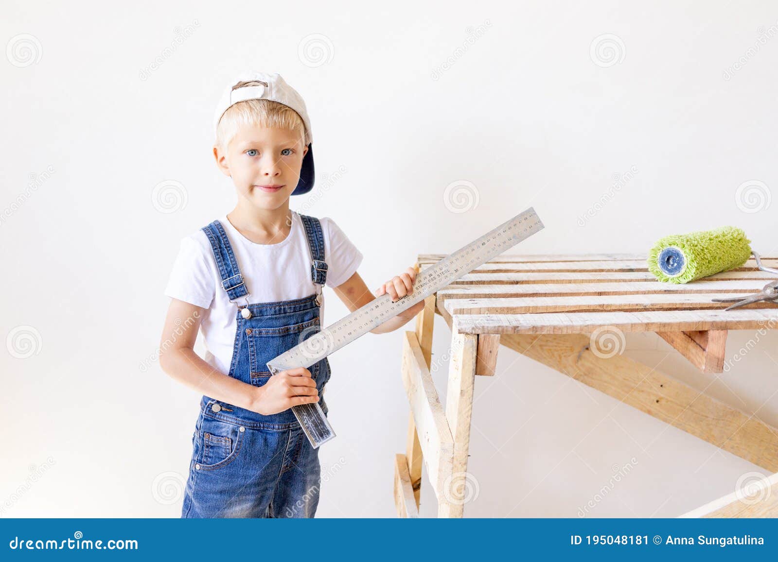 Child Builder Measures a White Wall with a Construction Ruler, Space ...