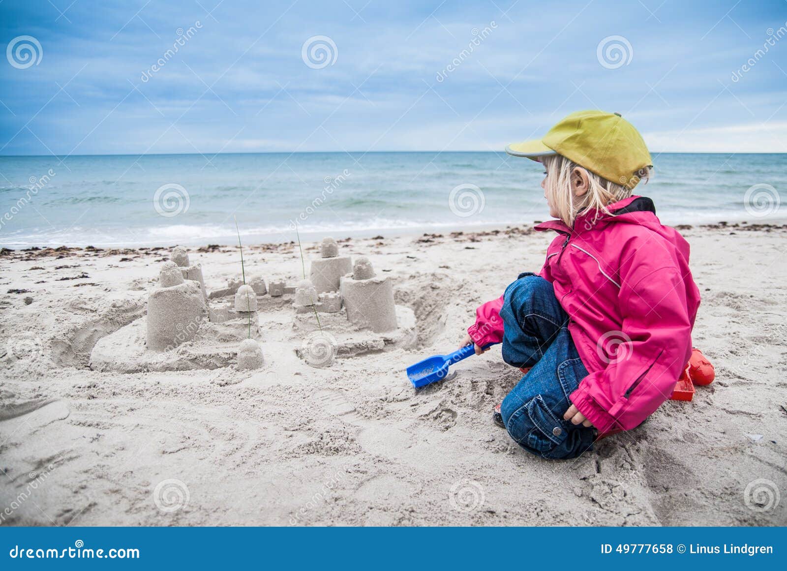 Child Building Sand Castle Near the Ocean Stock Photo - Image of shore ...