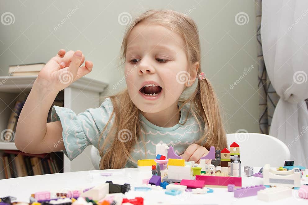 Child Builds with Constructor Bricks, Plays with Toys Stock Photo ...