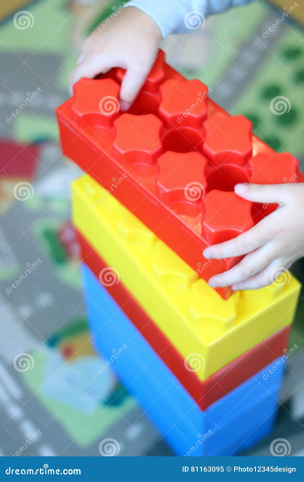 The Child Builds A Tower Out Of Bricks Constructor Stock Photo ...