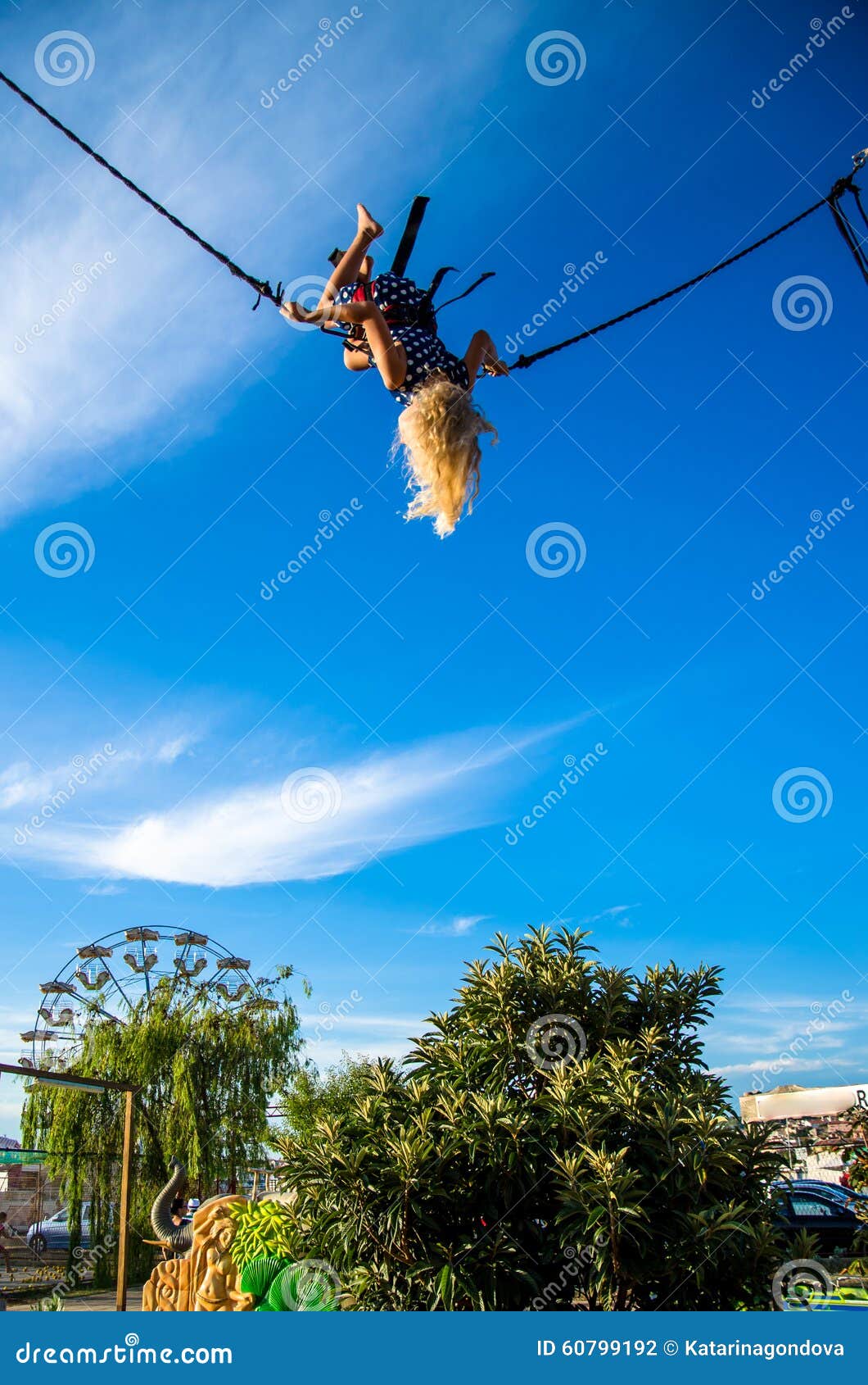 Child on bungee attraction stock photo. Image of spin - 60799192