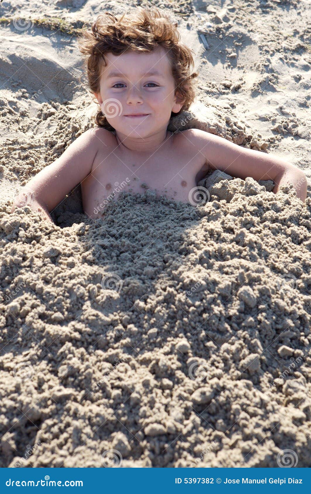 Child buried in the sand stock photo. Image of ocean, funny - 5397382