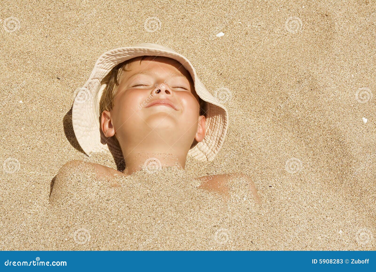 Child buried in the sand stock image. Image of blond, small - 5908283