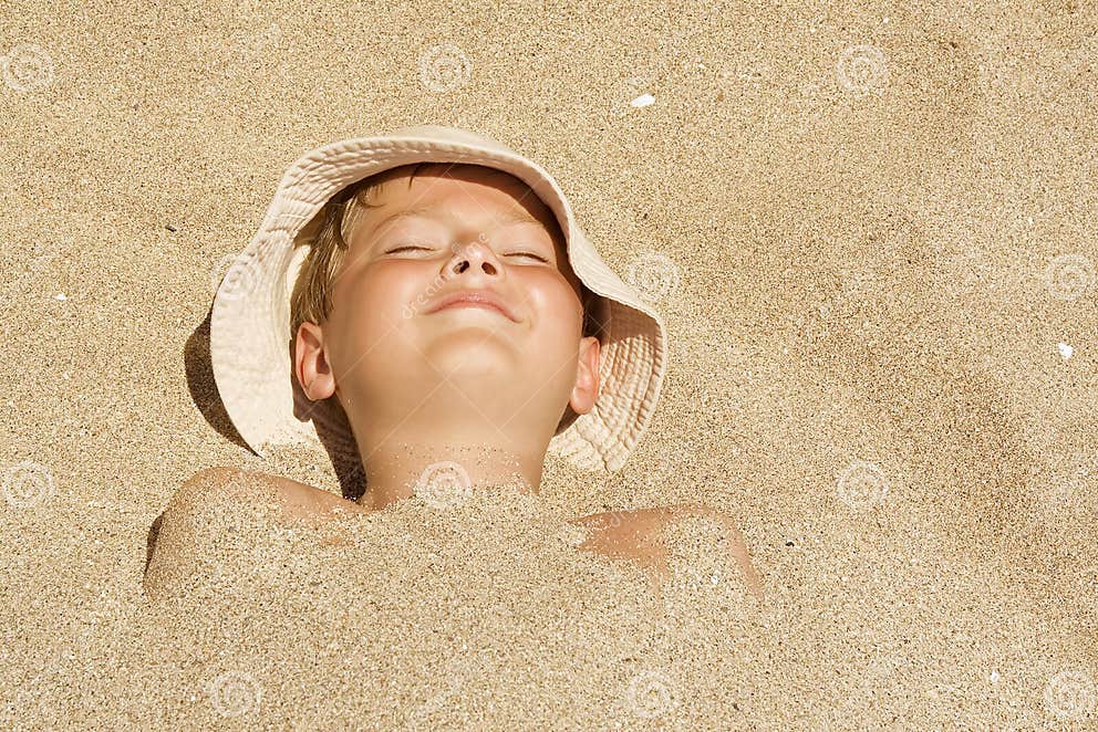 Child buried in the sand stock image. Image of blond, small - 5908283