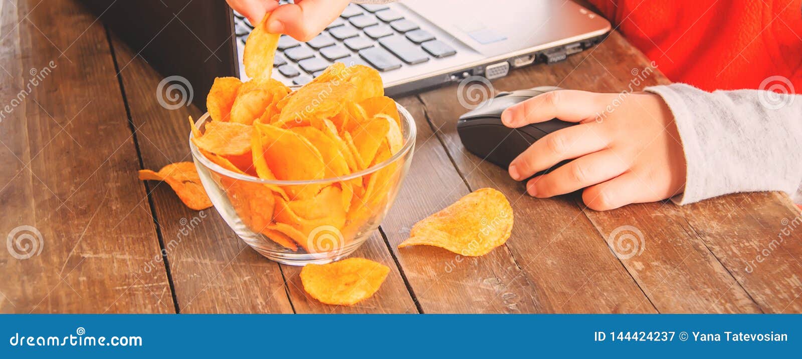 Child with Chips Behind a Computer. Selective Focus Stock Image - Image ...