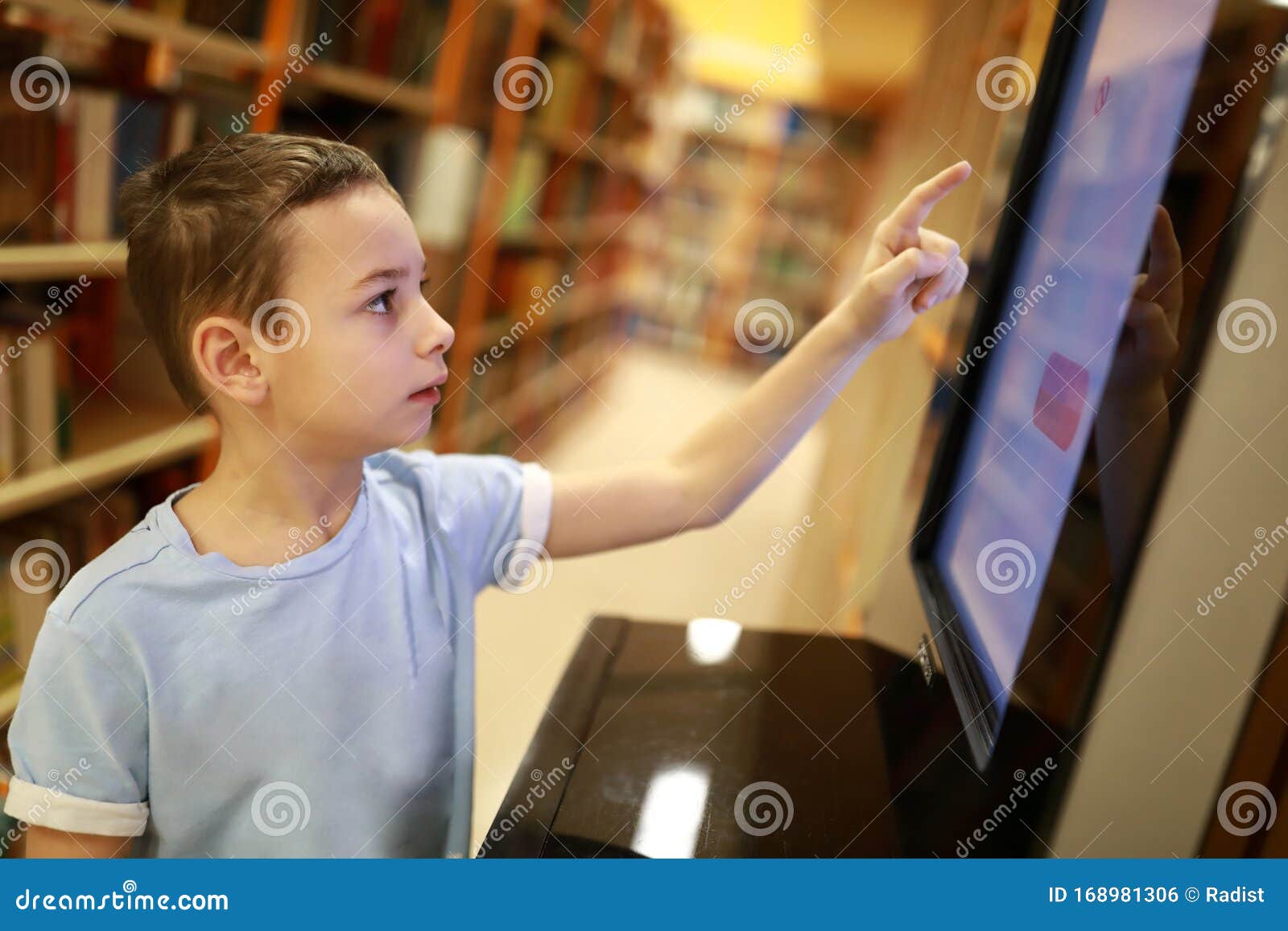 Child Choosing Book Using Touchscreen Stock Photo - Image of book ...