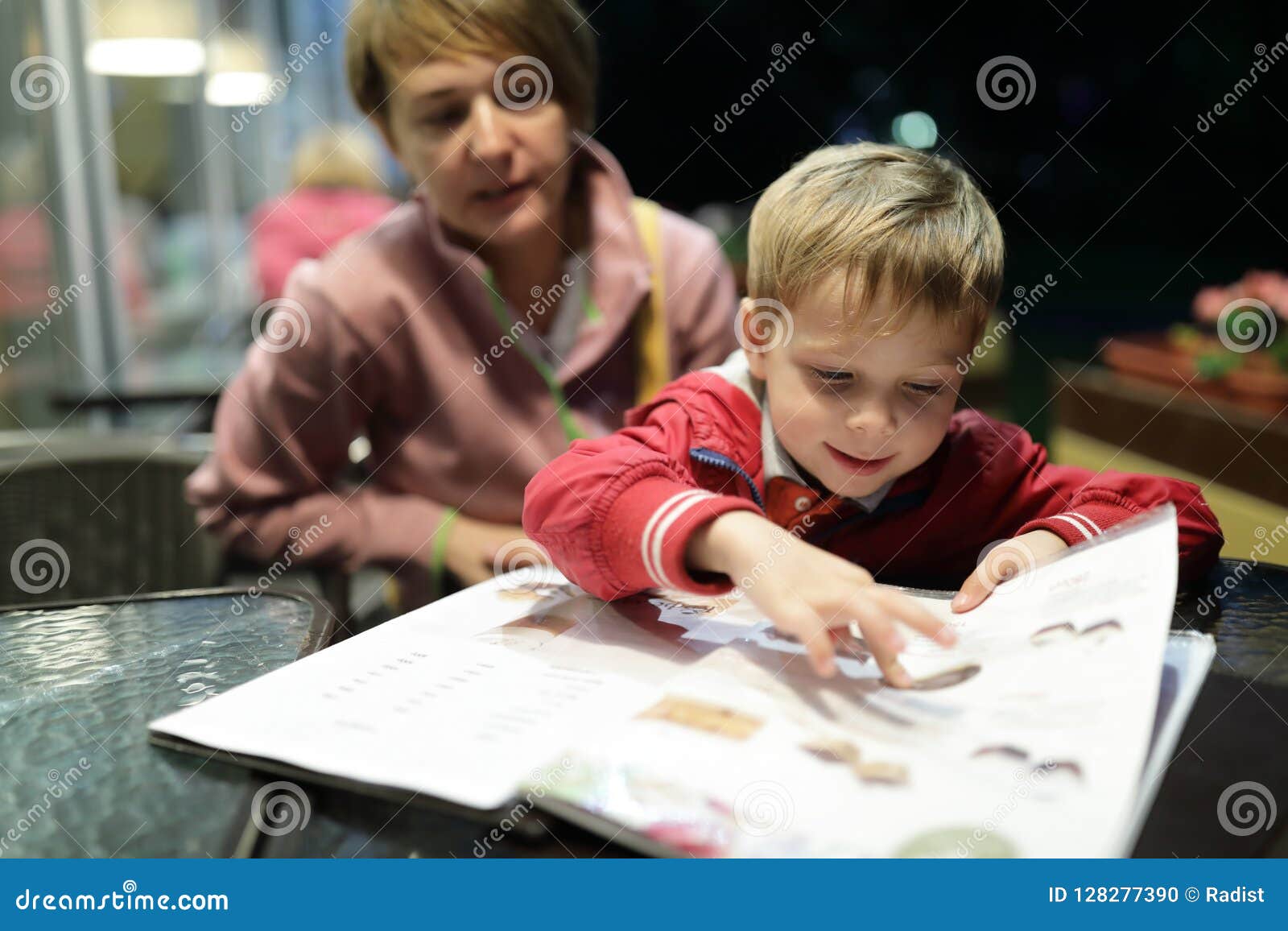 Child choosing dish stock photo. Image of food, book - 128277390