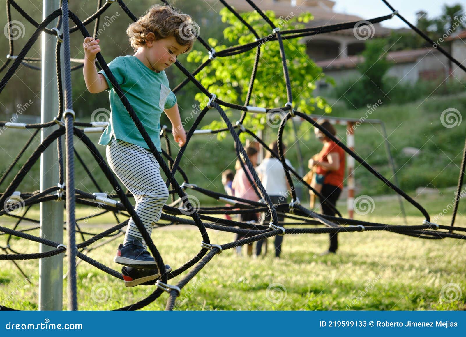 Child Climbing on a Rope-ladder Web in a Playground Stock Image - Image ...