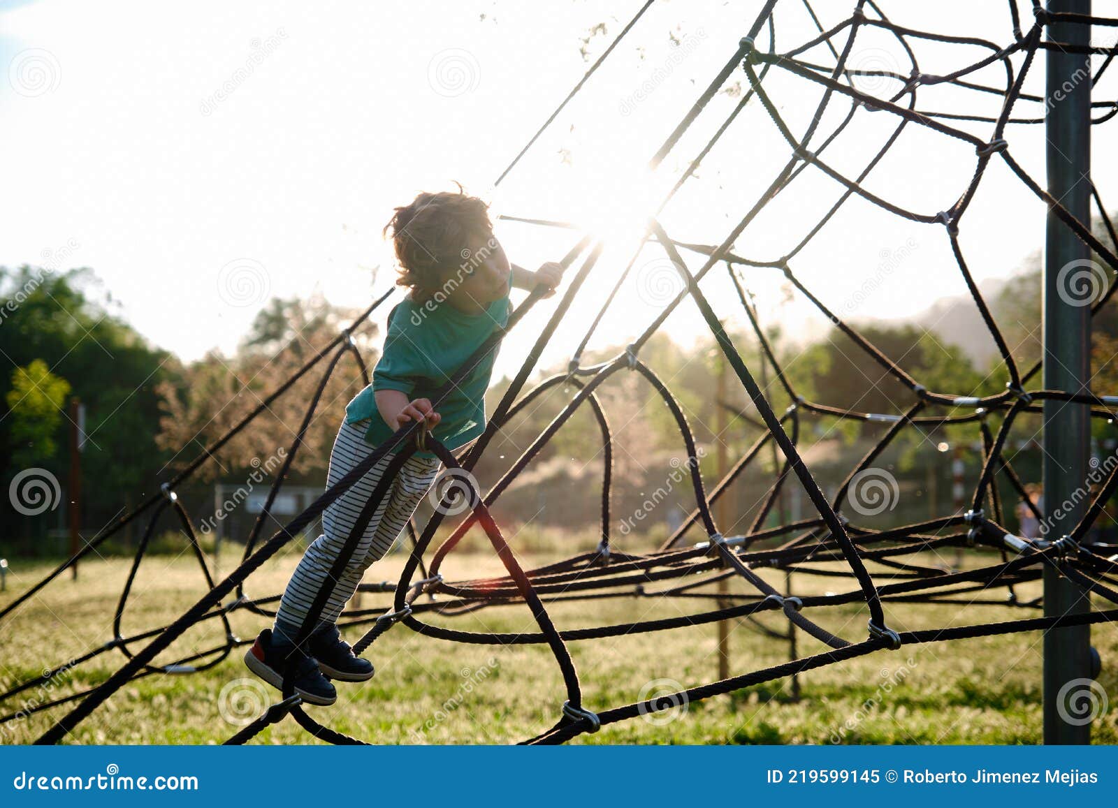 Child Climbing on a Rope-ladder Web in a Playground Stock Image - Image ...