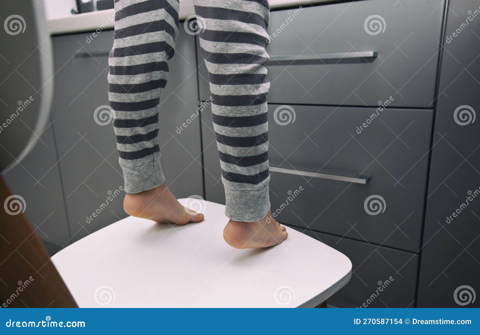 Child climbs on stool, stock photo. Image of little - 270587154