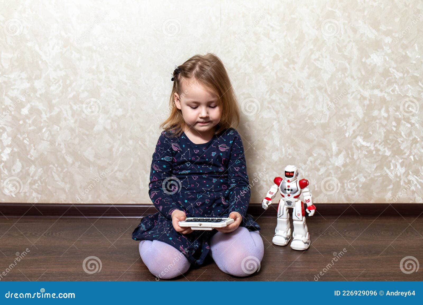 The Child Controls the Robot from the Remote Control Stock Photo ...