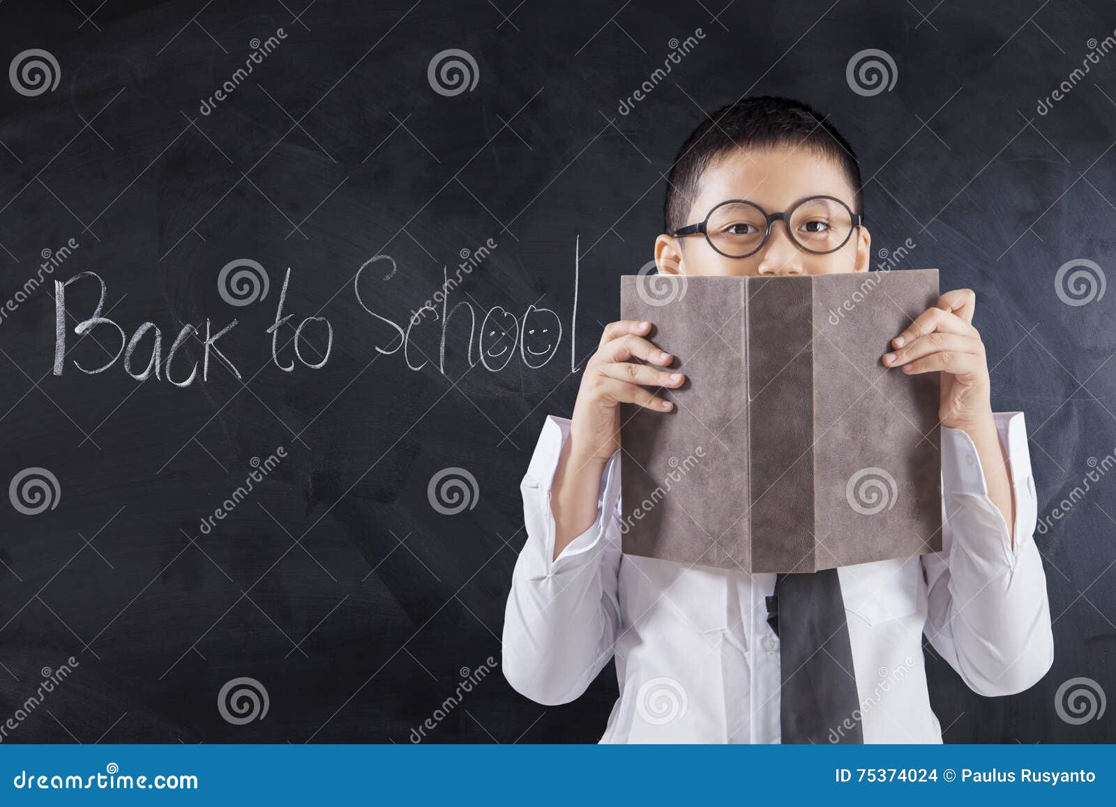 Child Covering His Face with Book in Class Stock Photo - Image of ...