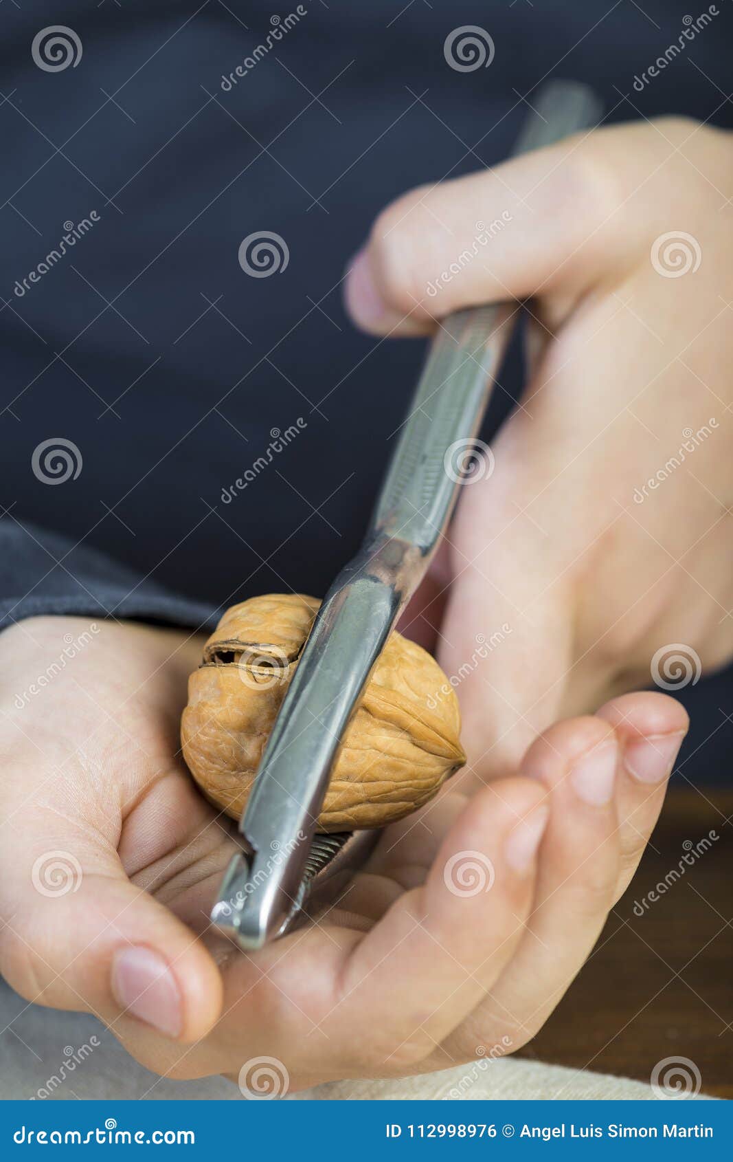 Child cracking walnuts stock photo. Image of shell, child - 112998976