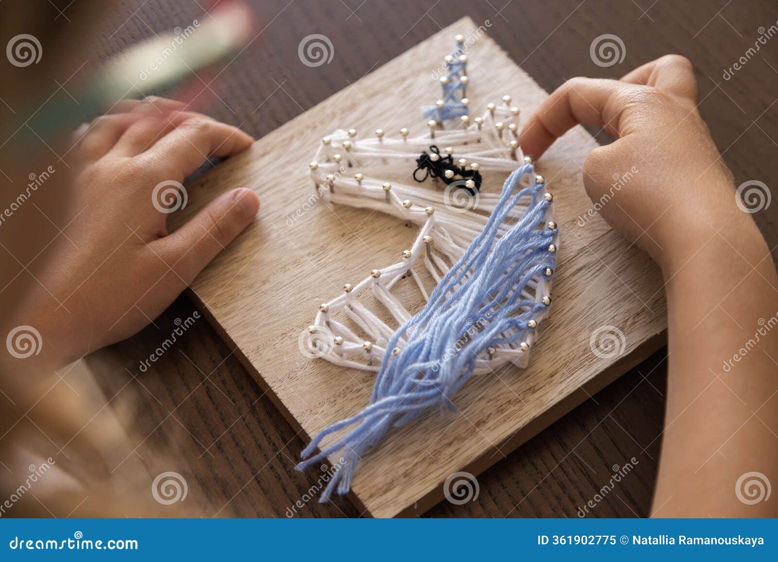Child Creates Intricate String Art. Fostering Focus, Creativity ...