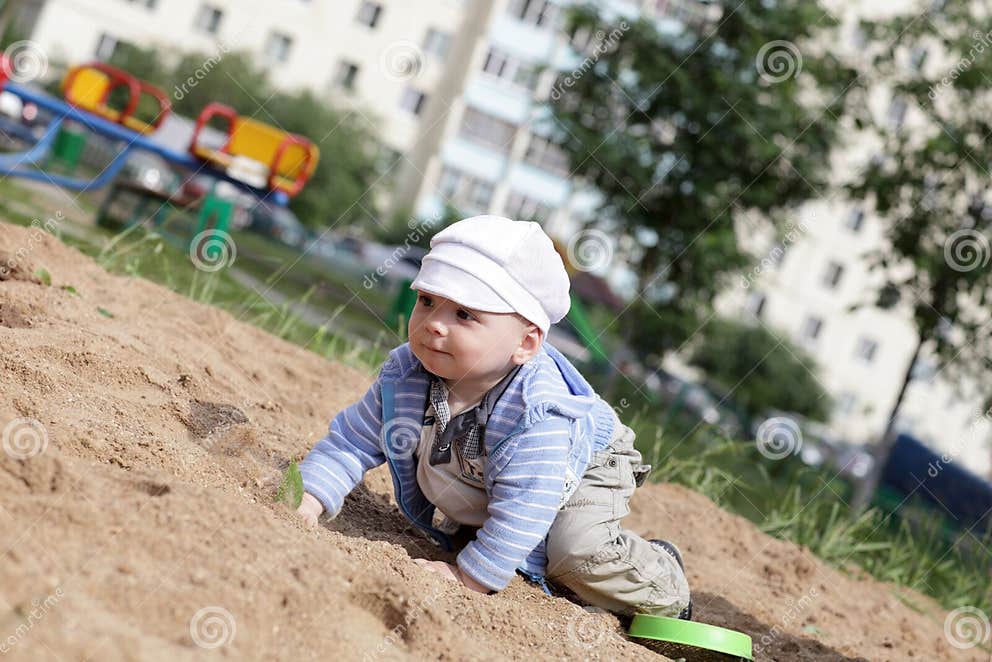 Child creeping in sandbox stock photo. Image of childhood - 25910262