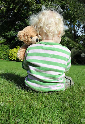Child cuddling teddy bear stock image. Image of embrace - 16188541