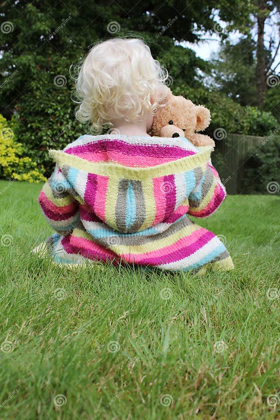 Child cuddling teddy bear stock photo. Image of curly - 16191912