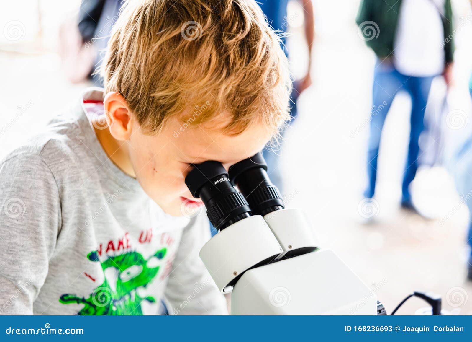 Child with Curiosity during a Medicine Fair Looking at Bacteria through ...