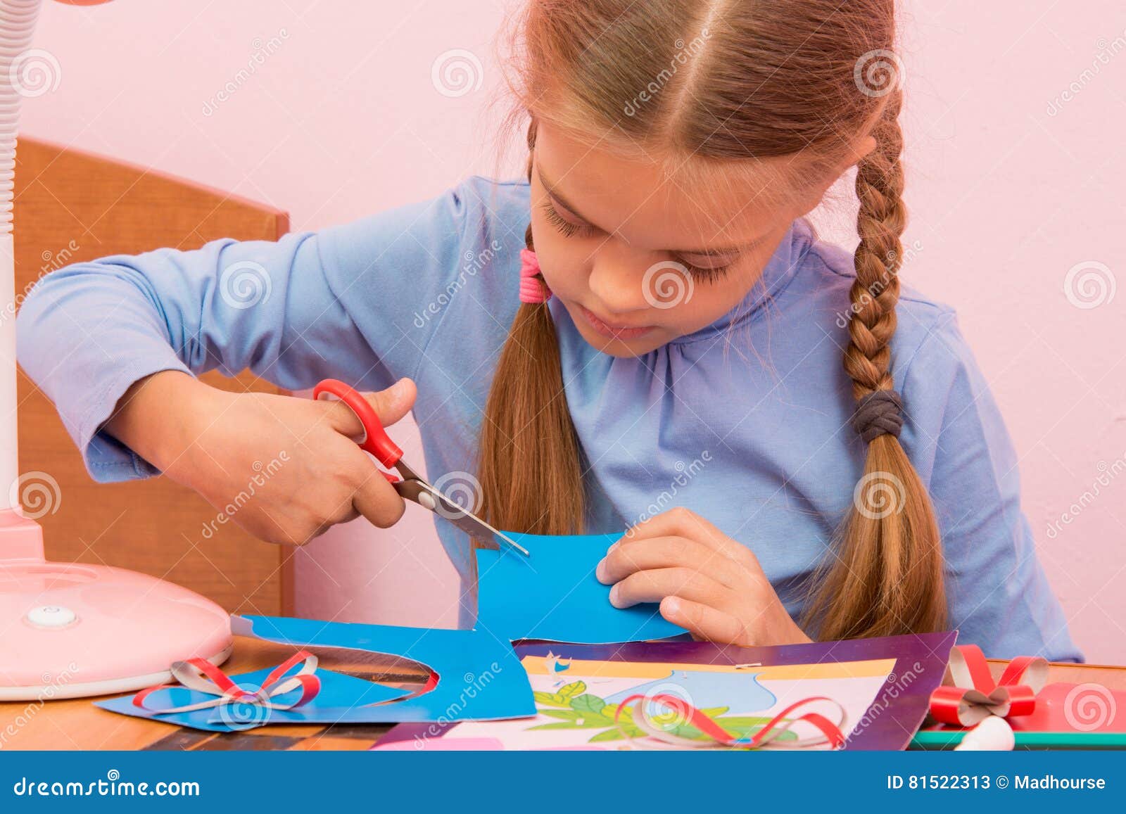 The Child Cuts Off Piece of the Blue Colored Cardboard Stock Image ...