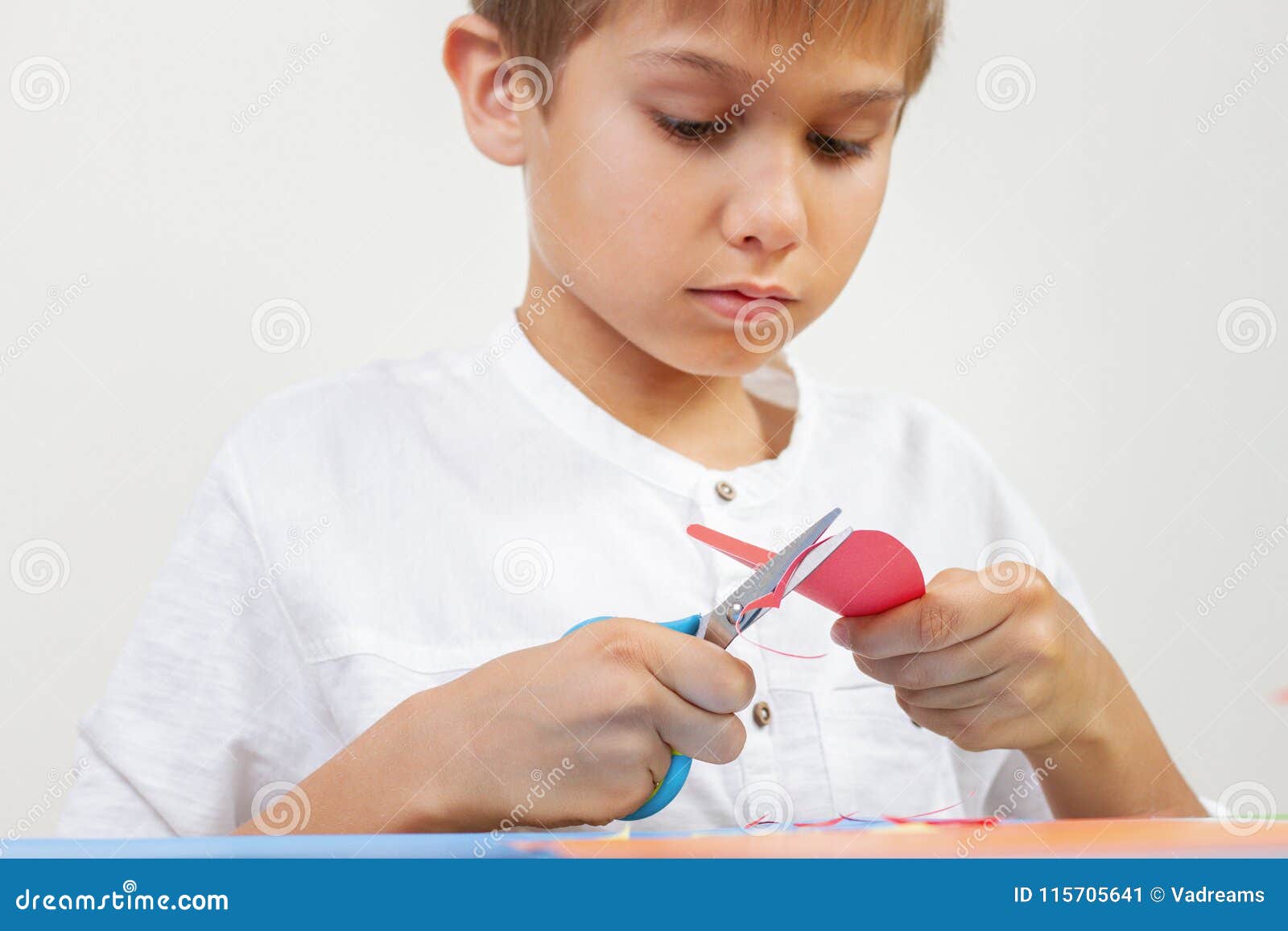 Child Cutting Paper In Class. Development Social Lerning In School ...