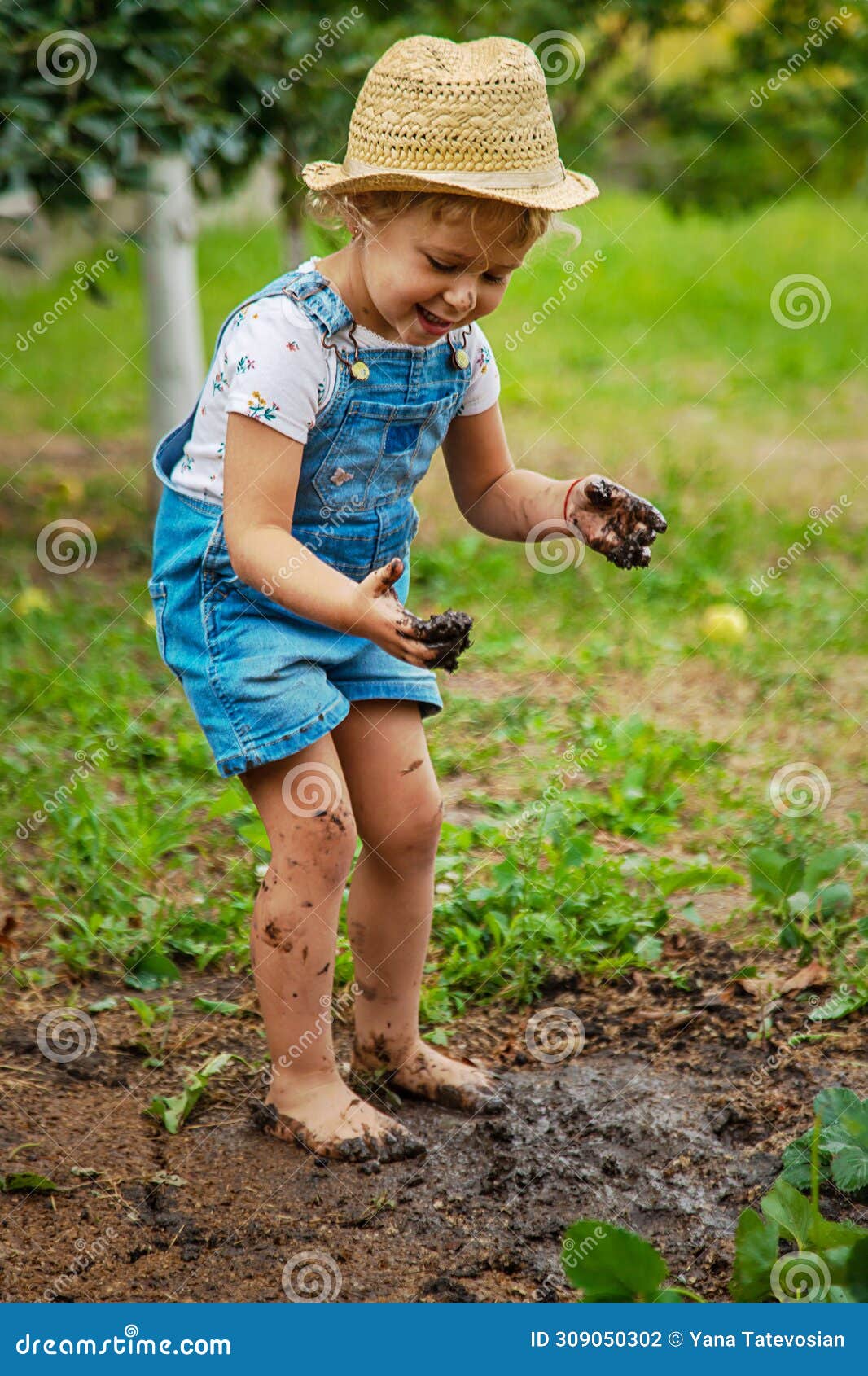 A Child in the Dirt in the Garden Holds the Soil in His Hands ...