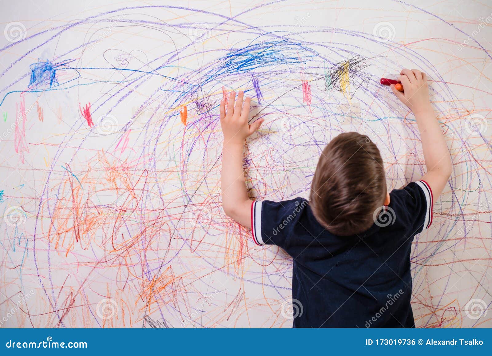 The Child Draws on the Wall with a Crayon. the Boy is Engaged in ...