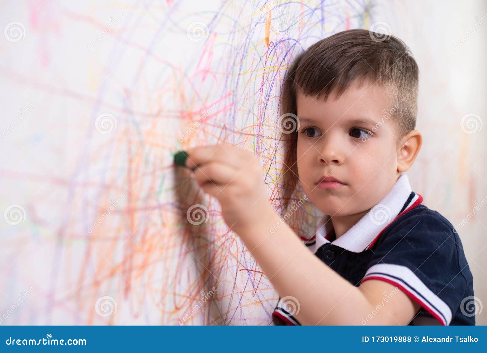 The Child Draws on the Wall with a Crayon. the Boy is Engaged in ...