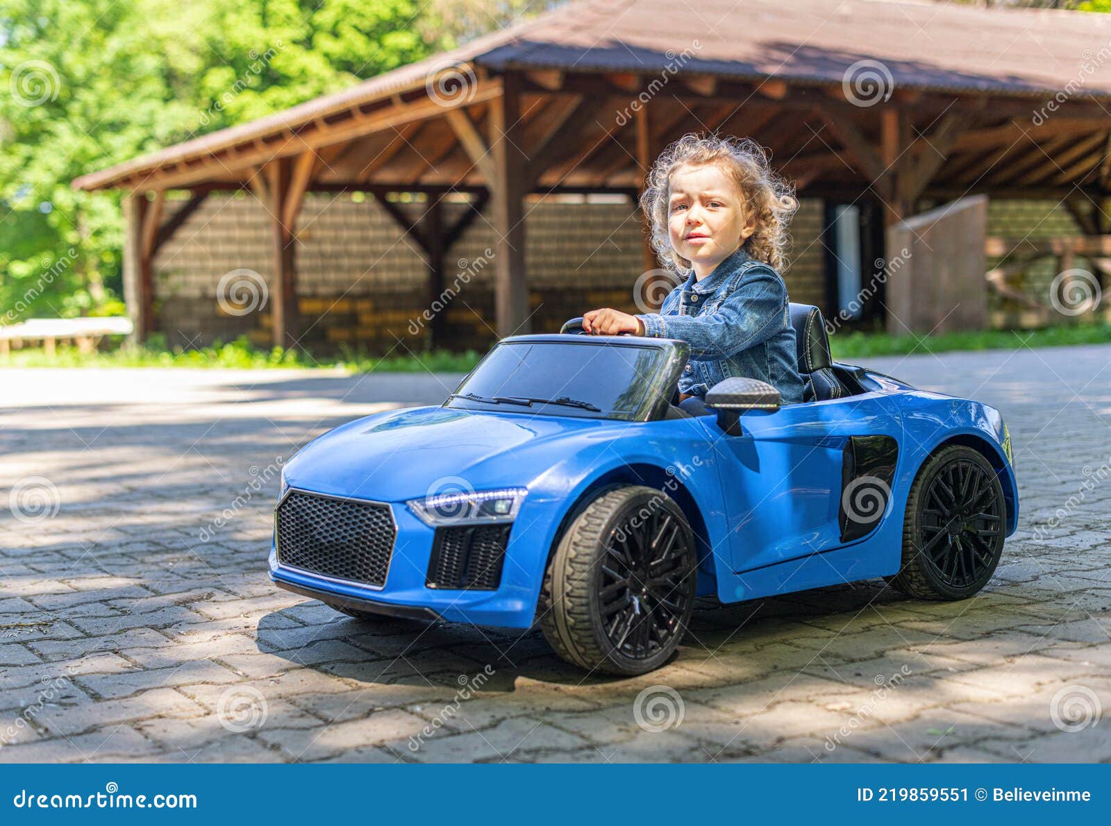 Child is Driving a Toy Car in the Park. Stock Image - Image of ...