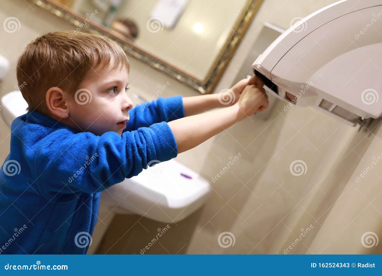 Child drying his hands stock image. Image of electrical - 162524343