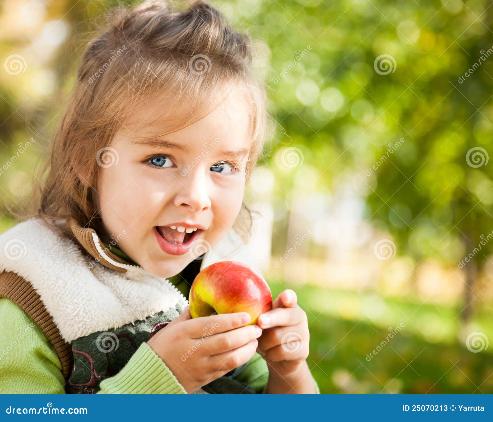Child eating apple stock image. Image of green, face - 25070213
