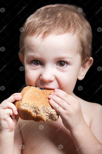 Child eating bread stock photo. Image of charity, hand - 16776328