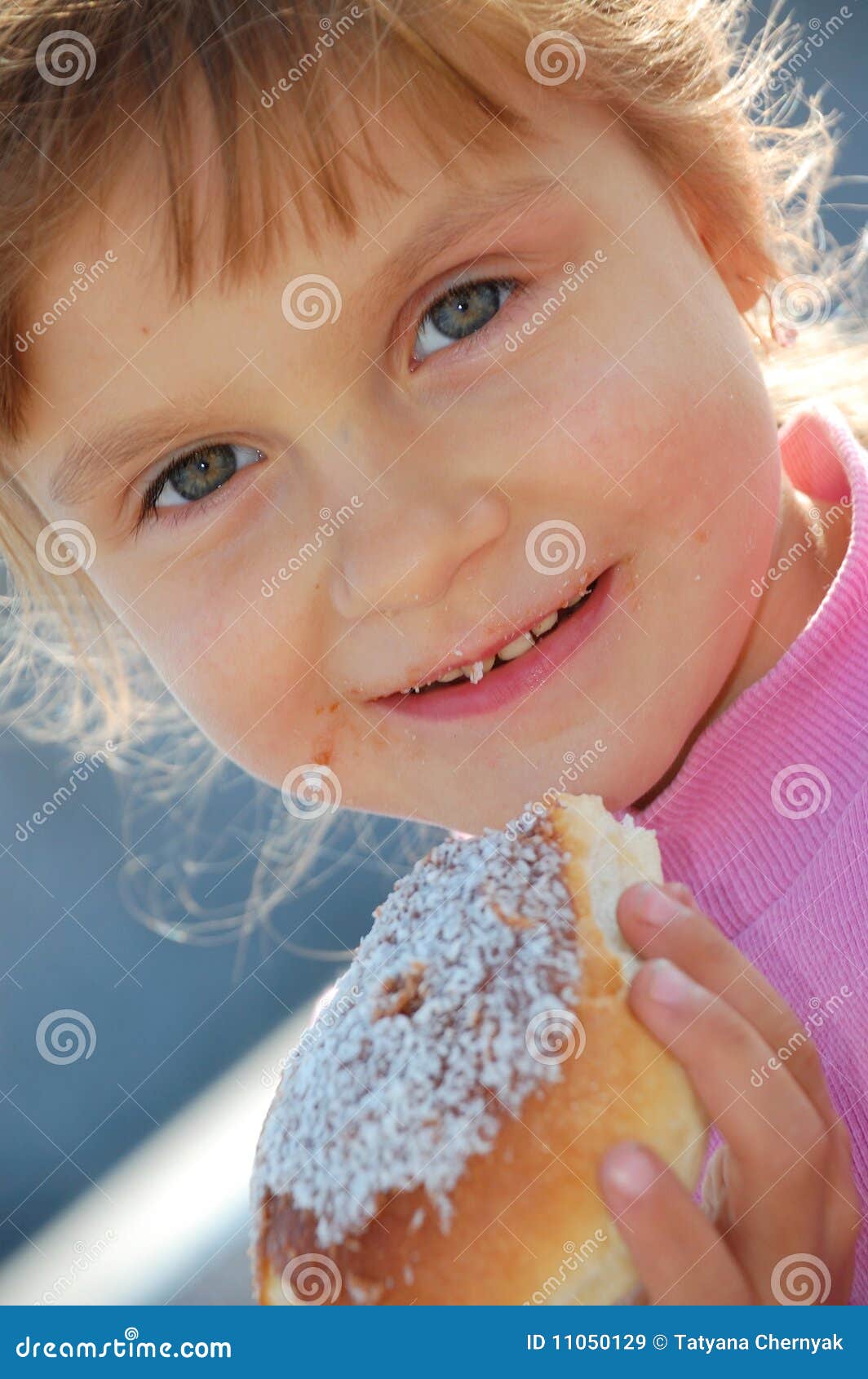 Child eating a bun stock image. Image of child, kids - 11050129
