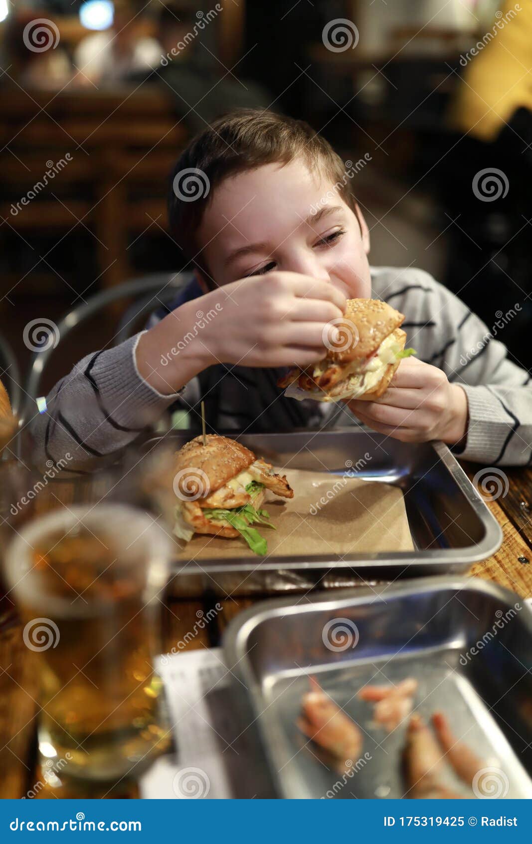 Child eating burger stock image. Image of appetite, childhood - 175319425