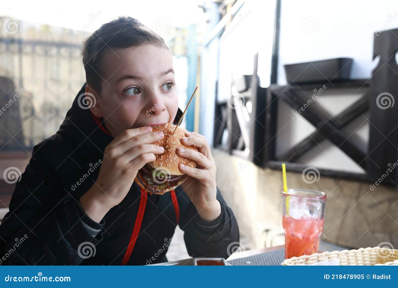 Child eating burger stock image. Image of hunger, feeding - 218478905