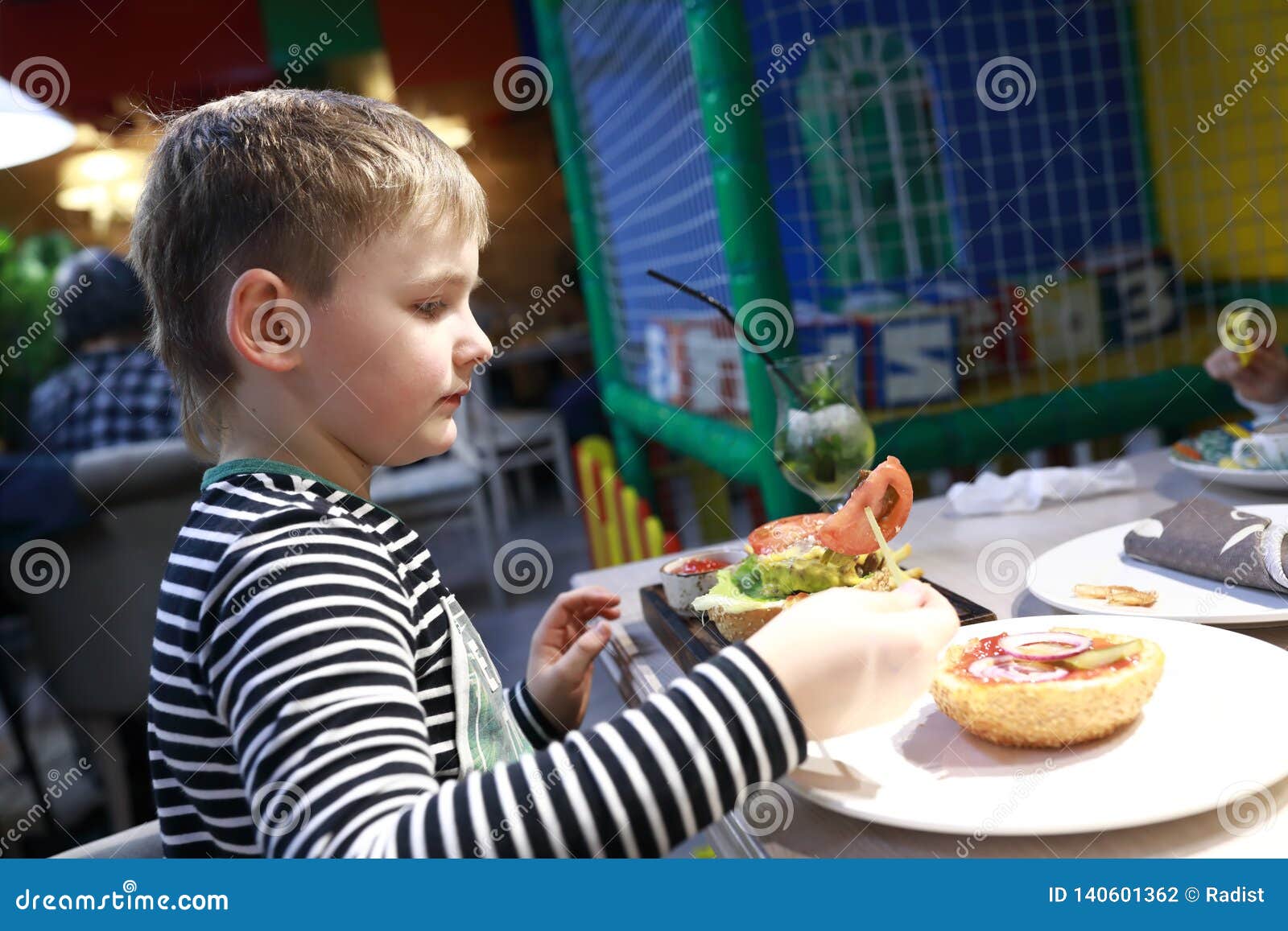 Child eating burger stock photo. Image of eating, alone - 140601362