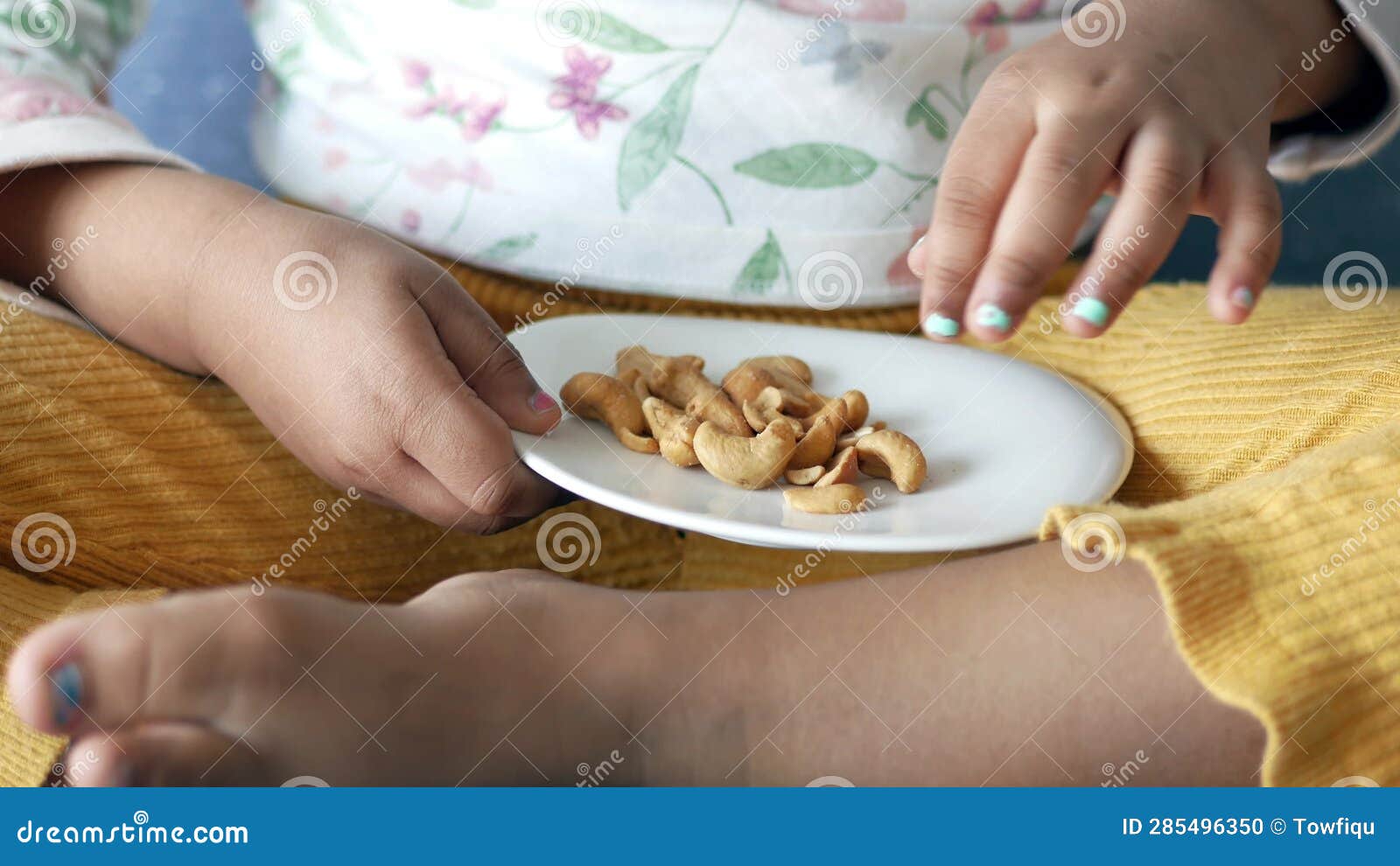 Child Eating Cashew Nuts Sitting on Sofa Stock Footage - Video of ...