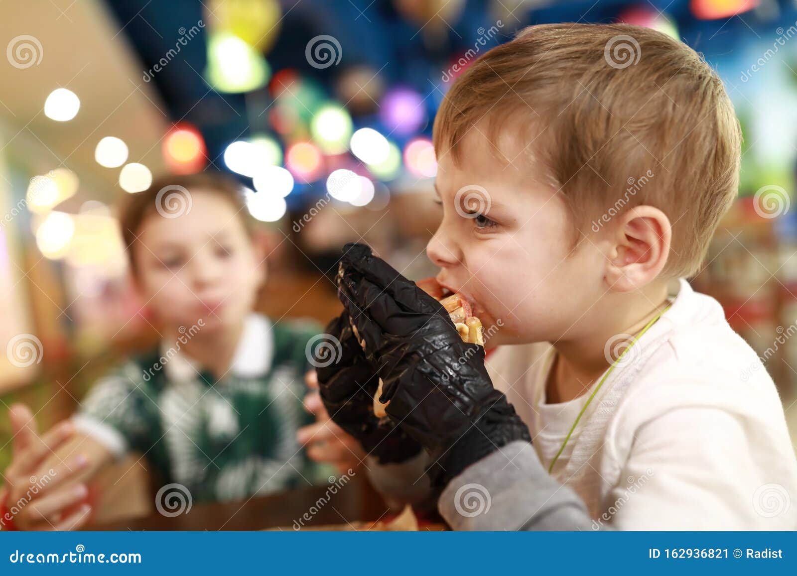 Child eating Cheeseburger stock image. Image of appetizing - 162936821