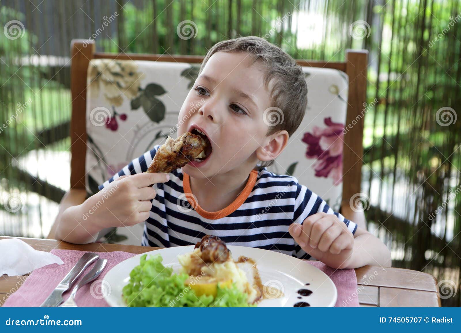 Child eating chicken leg stock image. Image of cuisine - 74505707