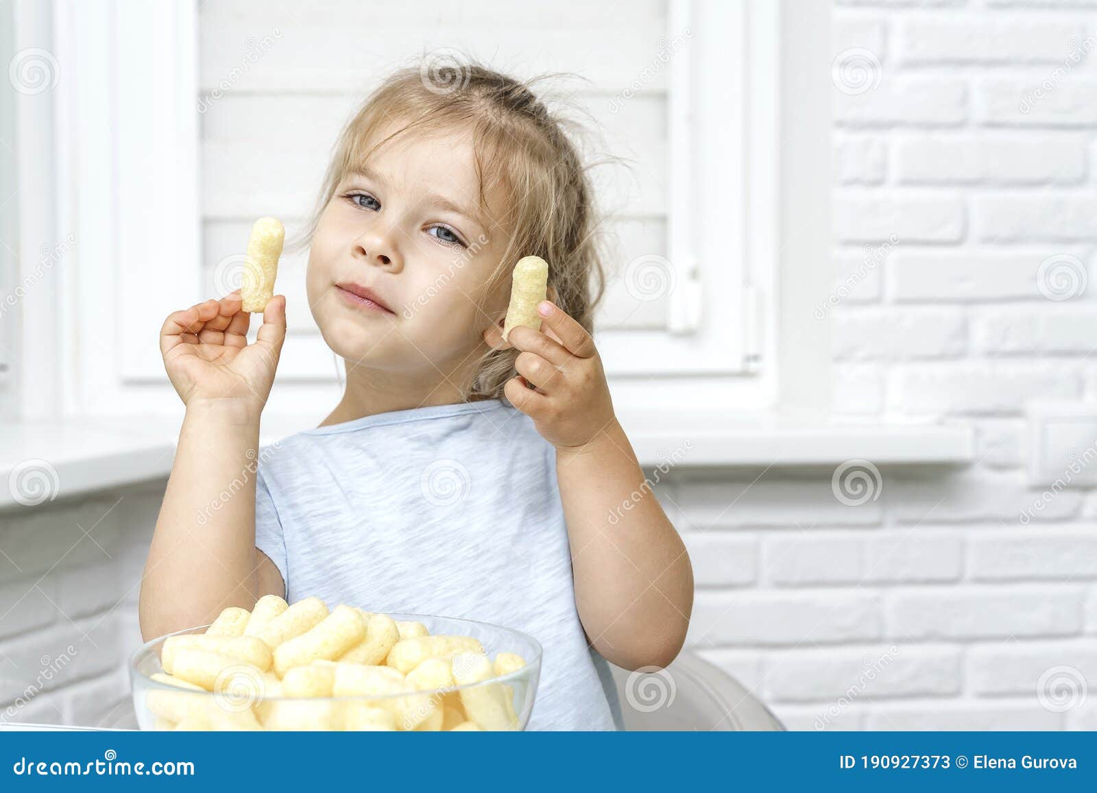 Child Eating Corn Sticks at the Kitchen Table Stock Image - Image of ...
