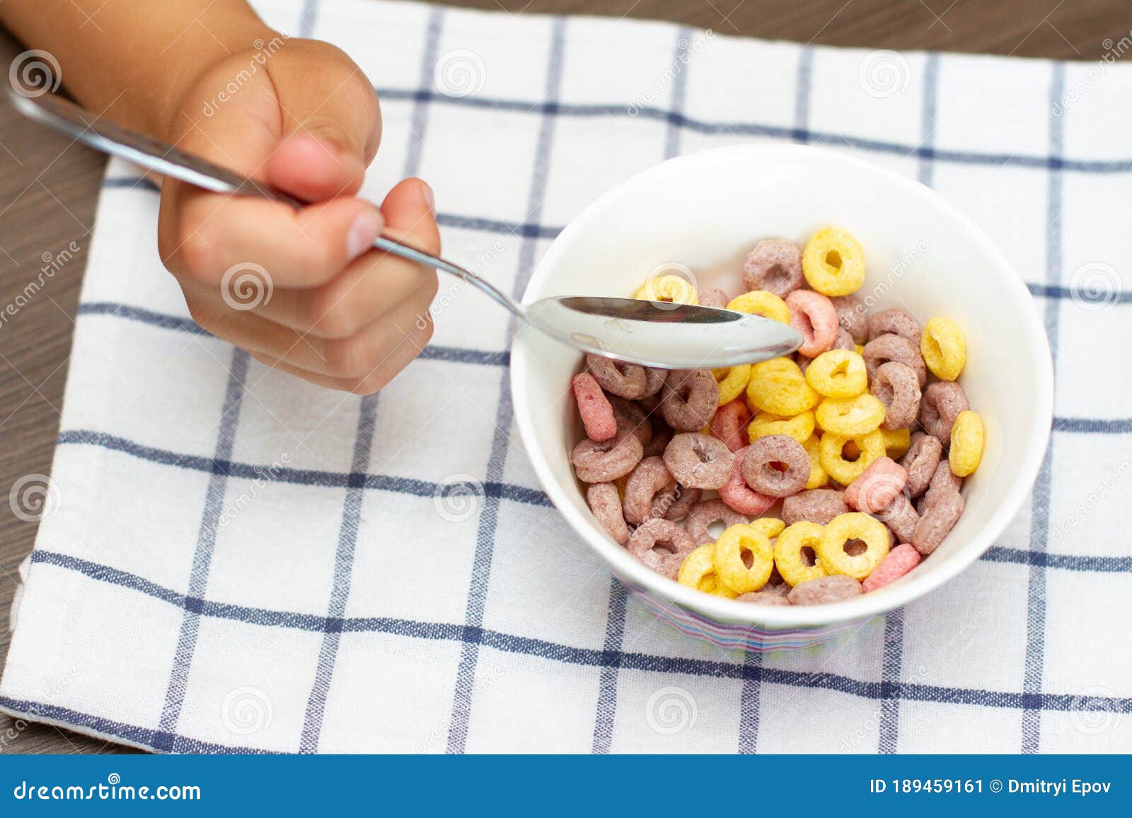 The Child is Eating Cornflakes. Child`s Hand with a Spoon Stock Image ...