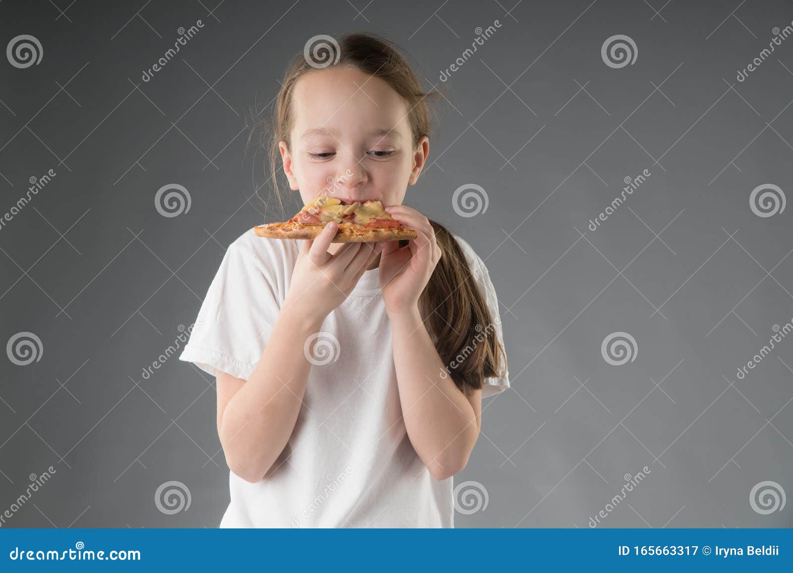 The child is eating pizza. stock image. Image of white - 165663317