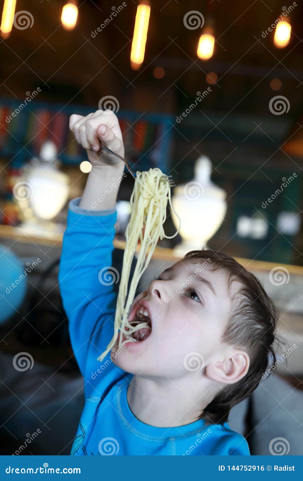 Child eating spaghetti stock photo. Image of hunger - 144752916