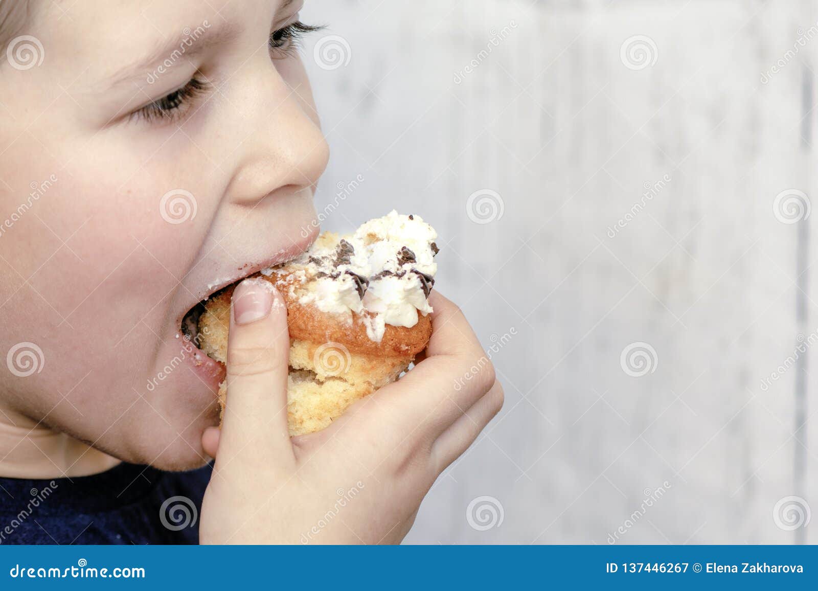The Child Eats a Delicious Sweet Cupcake, Cream Cake. Copy Space Stock ...