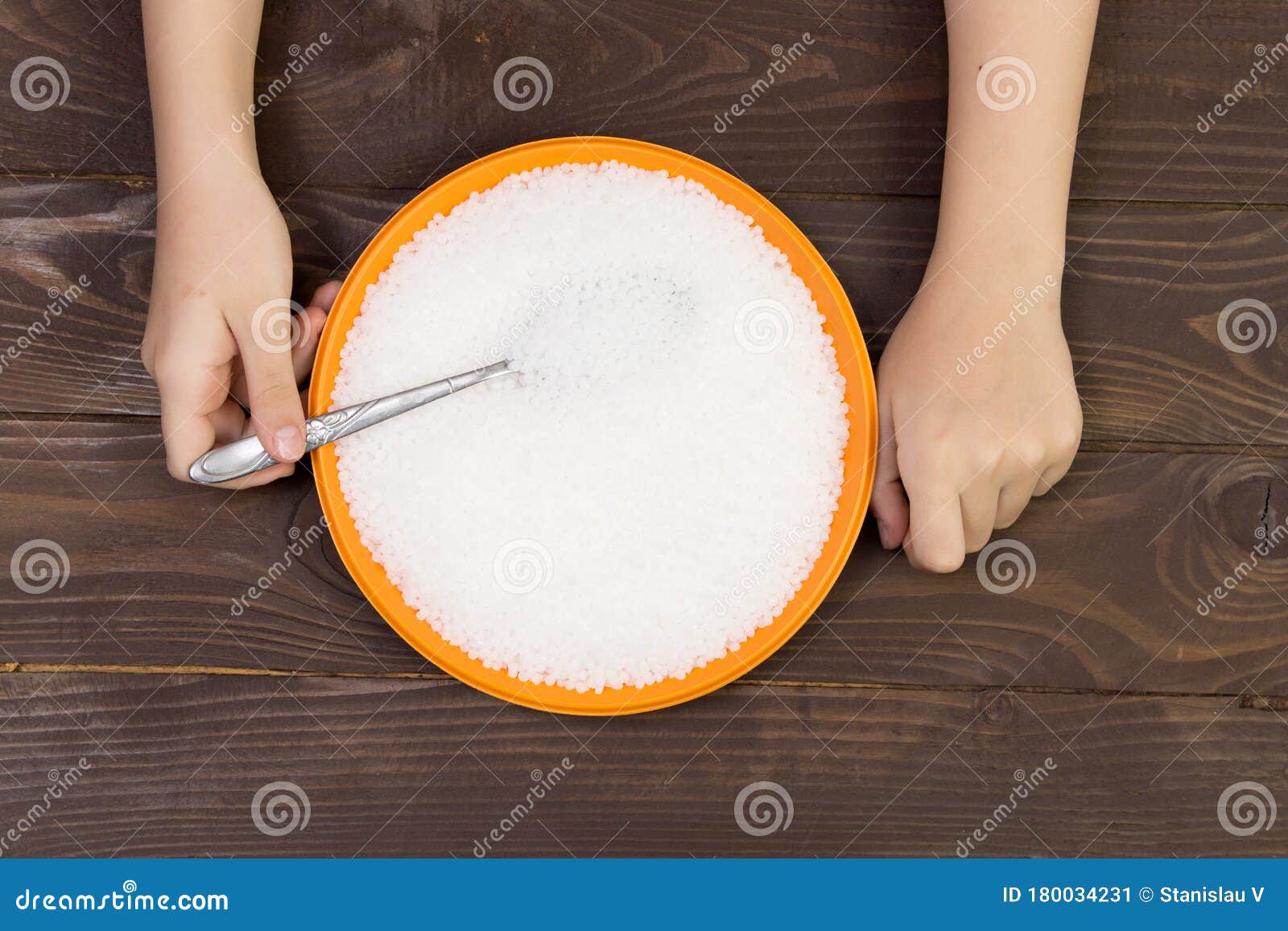 A Child Eats Plastic Pellets from a Plate .Concept of Environmental ...