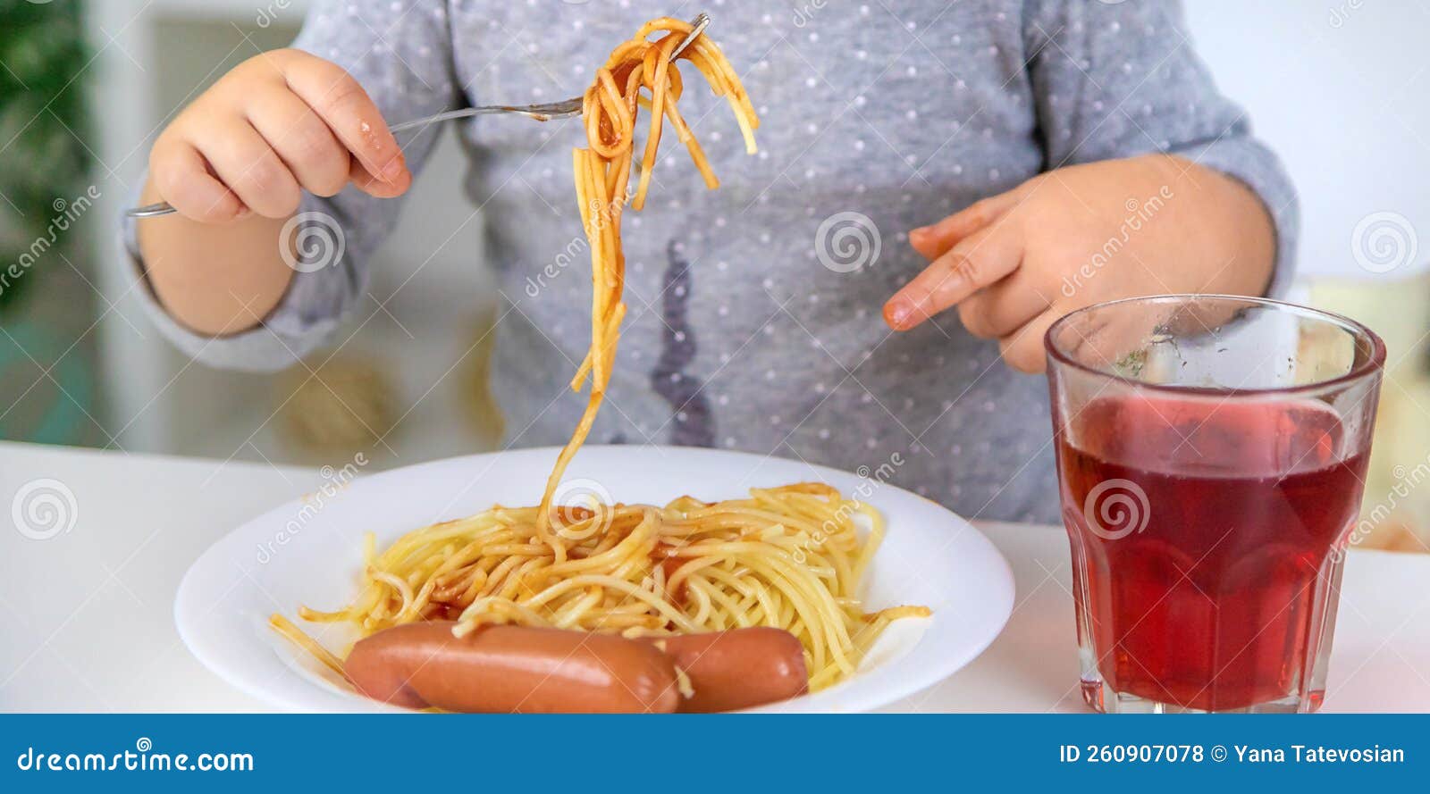 The Child Eats Spaghetti Lunch. Selective Focus Stock Photo - Image of ...