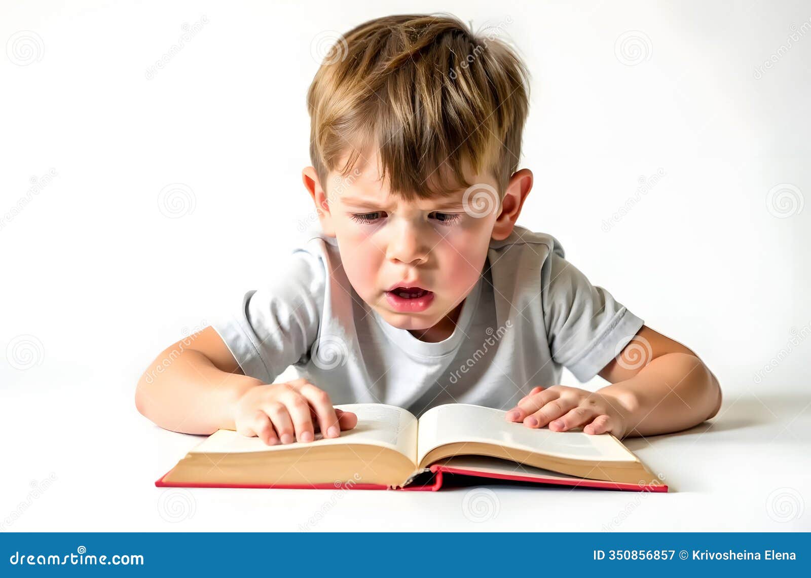 Child Engaged in Deep Concentration while Reading a Book with Focused ...