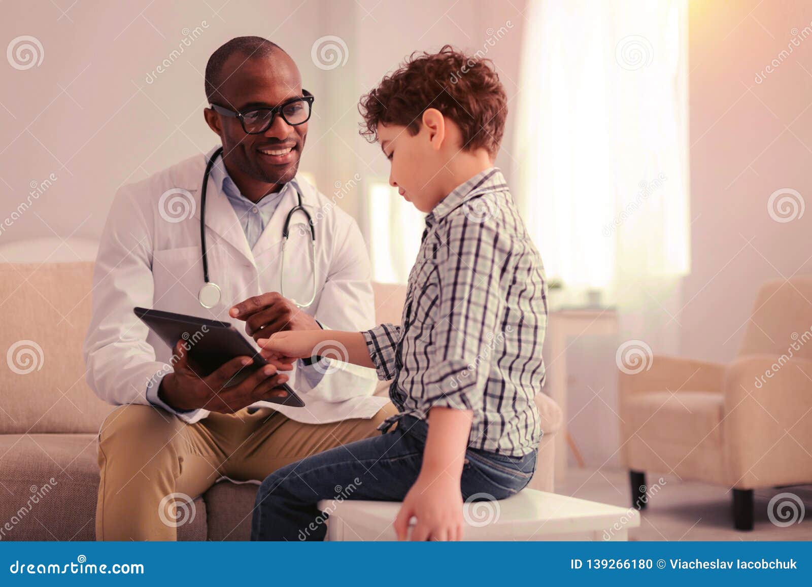 Child Explaining His Symptoms To the Doctor Using a Tablet Stock Photo ...